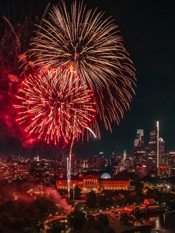 Large red and gold fireworks erupt in a dark sky over the Philadelphia Museum of Art in Philadelphia.